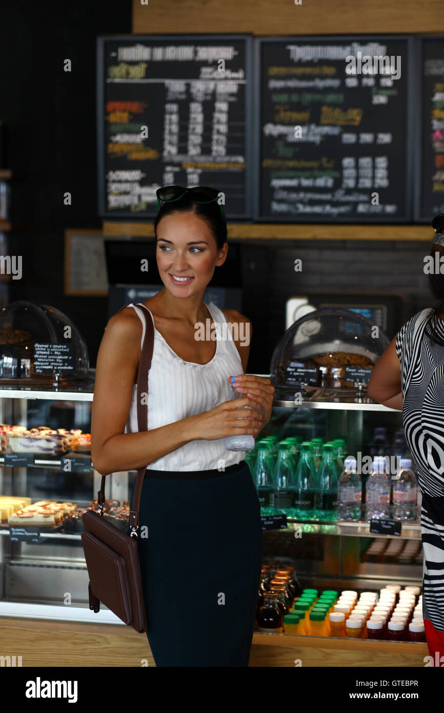 Young beautiful girl standing in line at the coffee shop Stock Photo ...