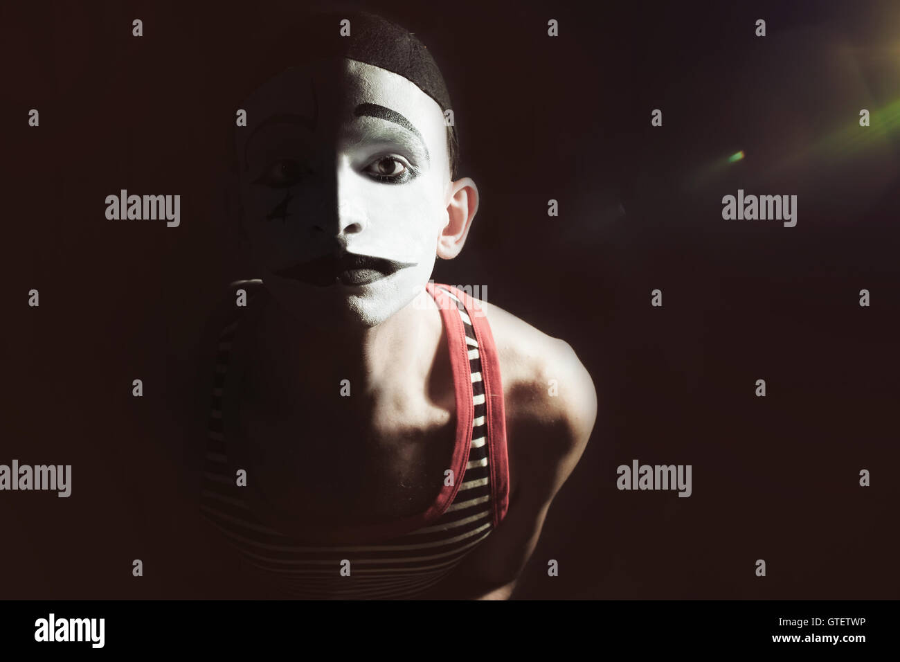 Portrait of sad mime wearing hat on black background Stock Photo - Alamy