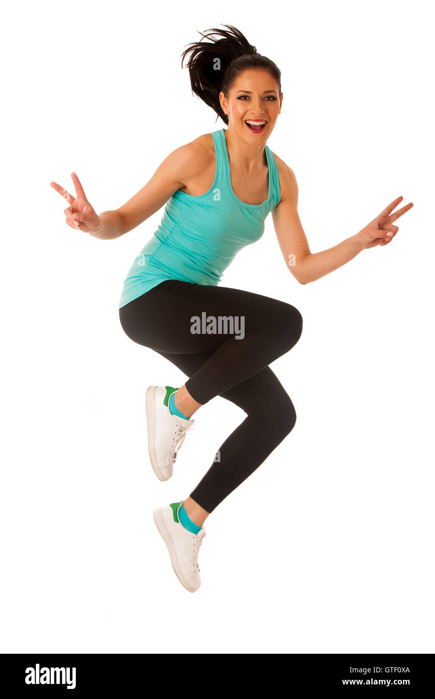 Happy fit and slim woman dancing and jumping isolated over white ...