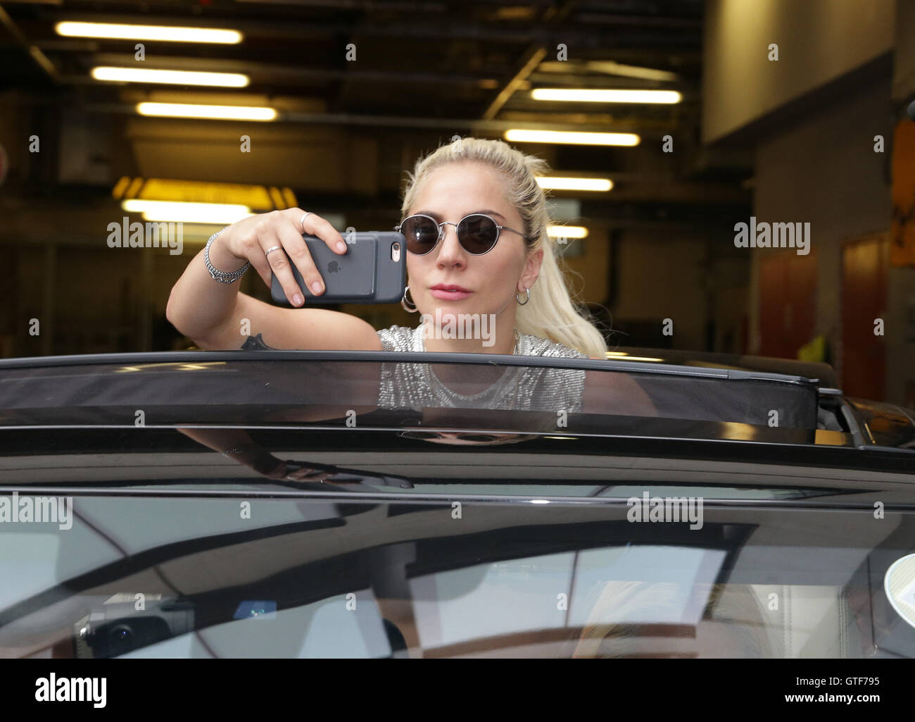 Lady Gaga takes a photo as she leaves BBC Broadcasting House in London ...