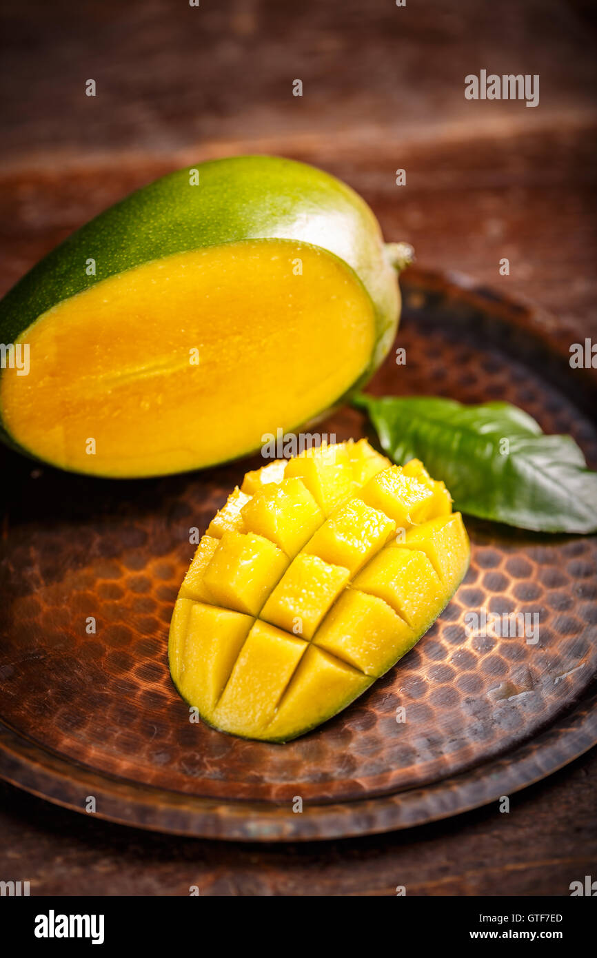 Mango slice cut to cubes on rustic background Stock Photo - Alamy