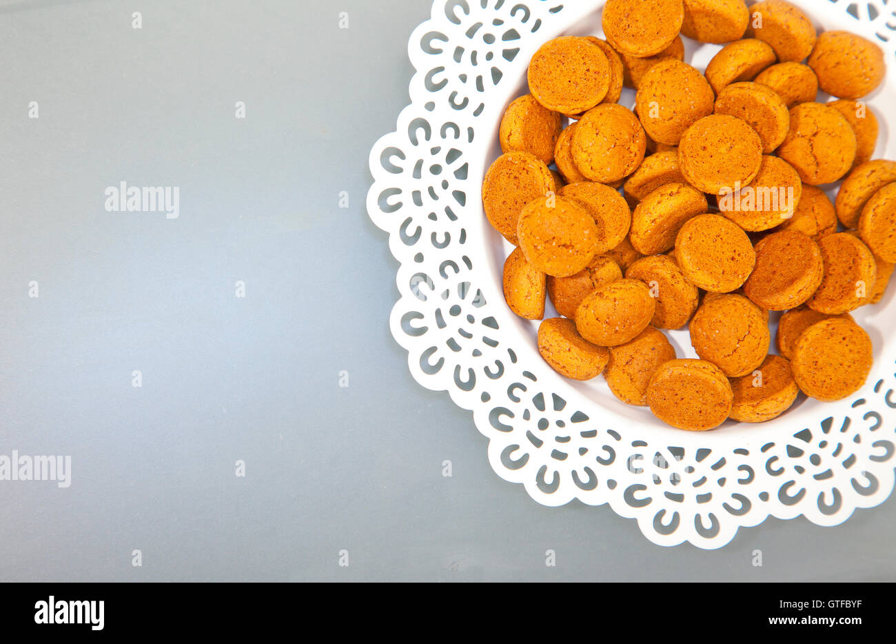 Traditional Dutch candy pepernoot on white plate on grey background ...
