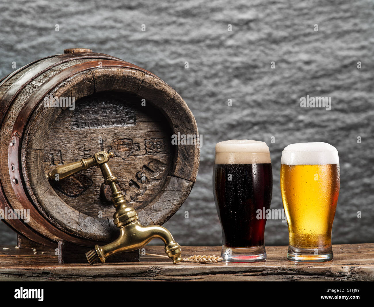 Glasses of beer and ale barrel on the wooden table. Craft brewery Stock ...