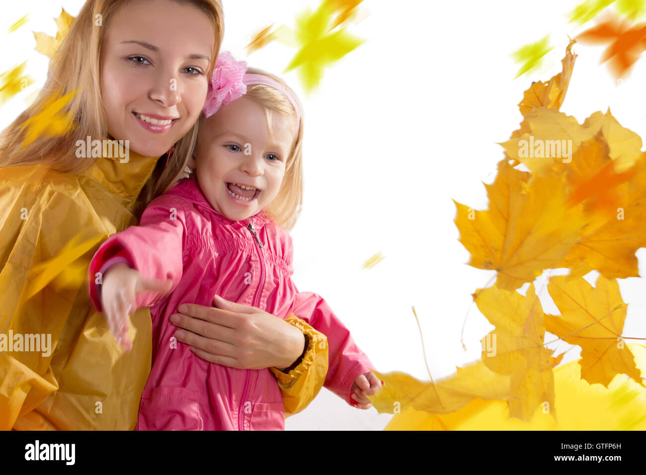 Mother and daughter catching falling leaves Stock Photo - Alamy