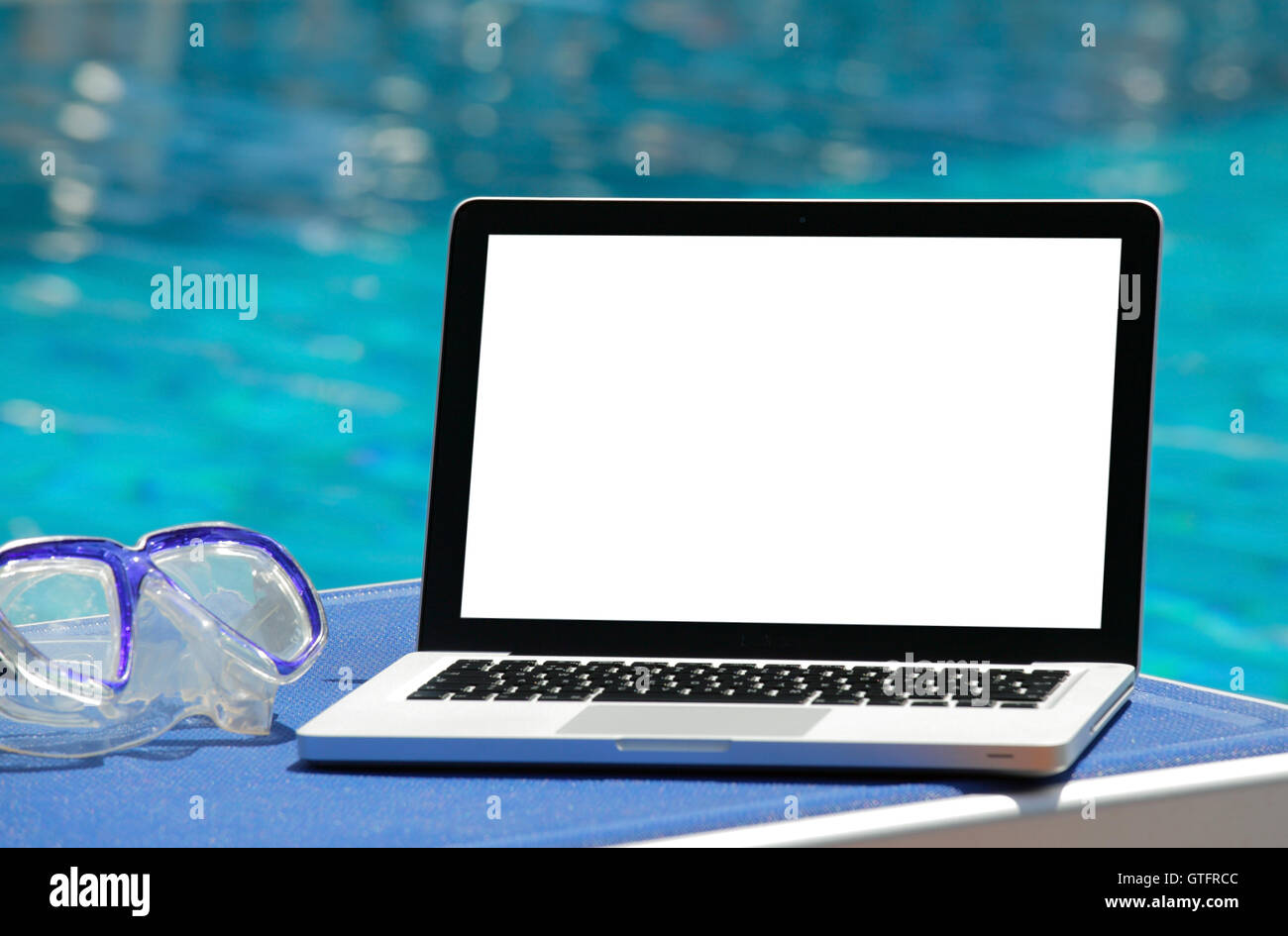 Laptop by swimming pool Stock Photo - Alamy