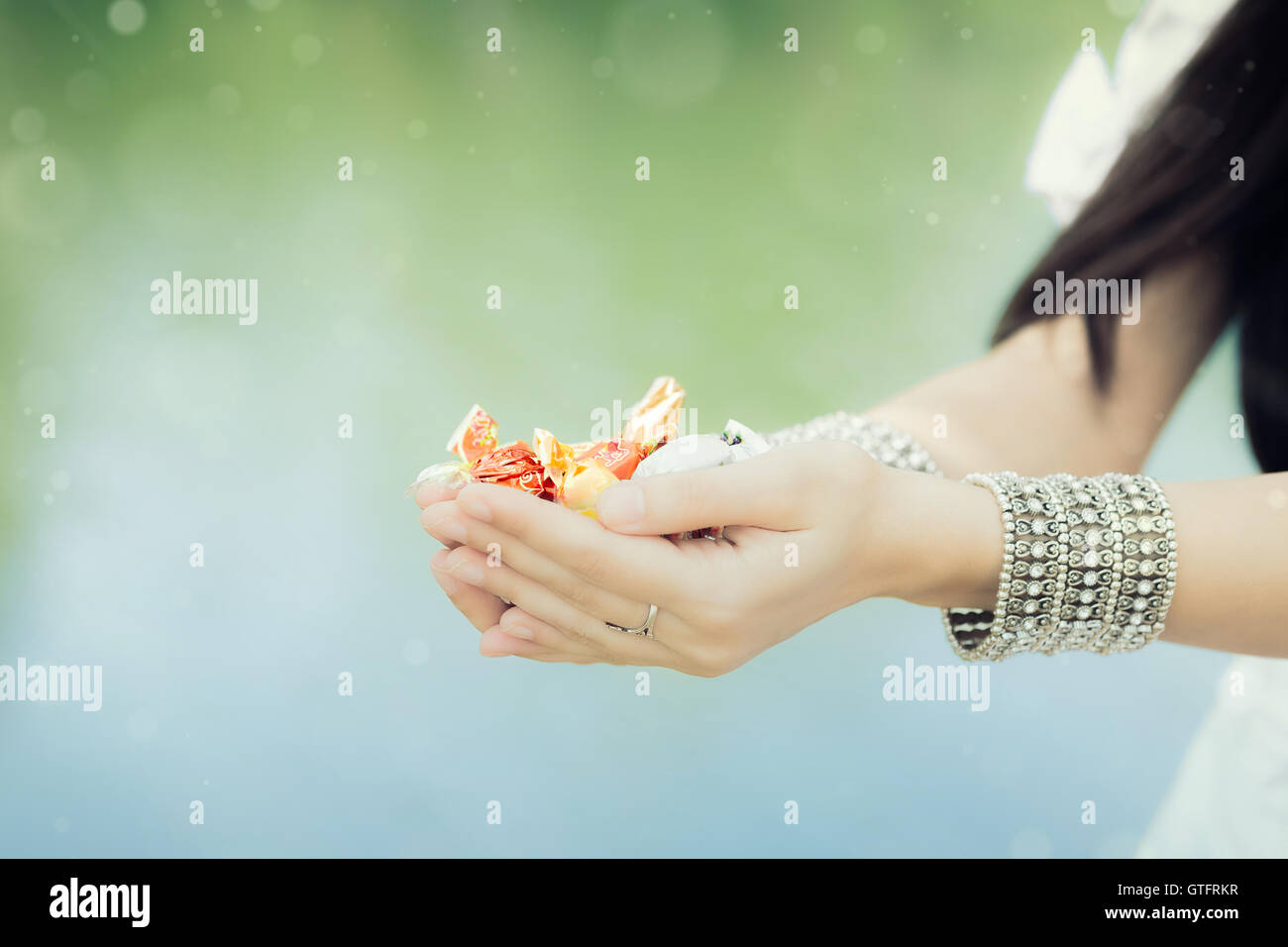 Sharing candy hands hi-res stock photography and images - Alamy