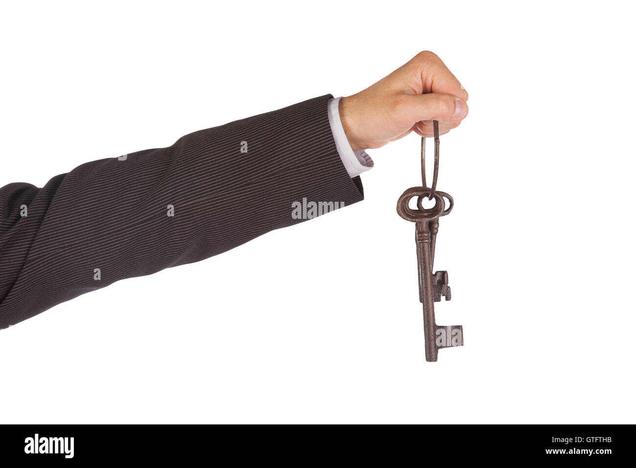 Man in suit giving old keys to a house Stock Photo - Alamy