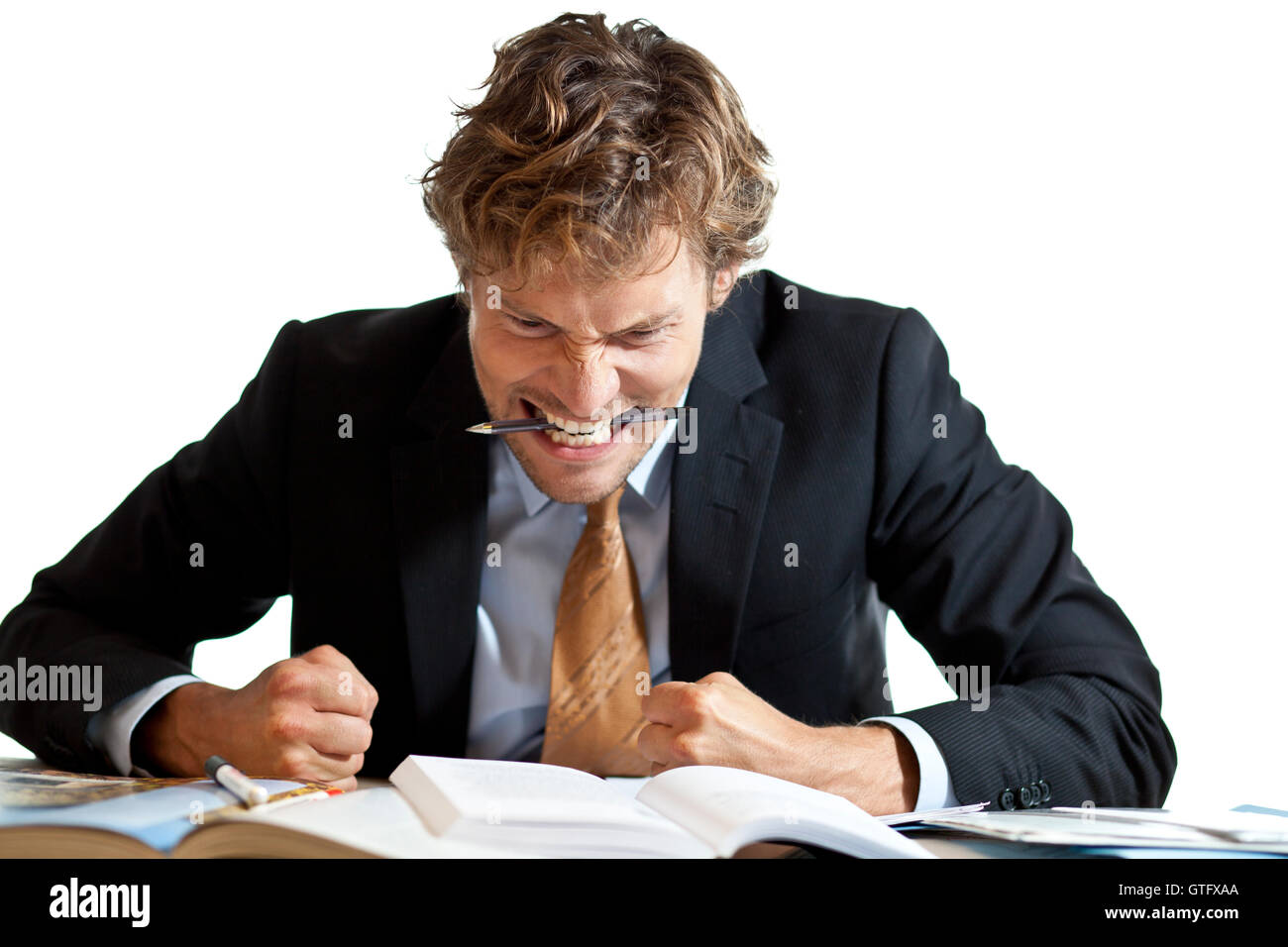 Angry businessman at desk Stock Photo - Alamy