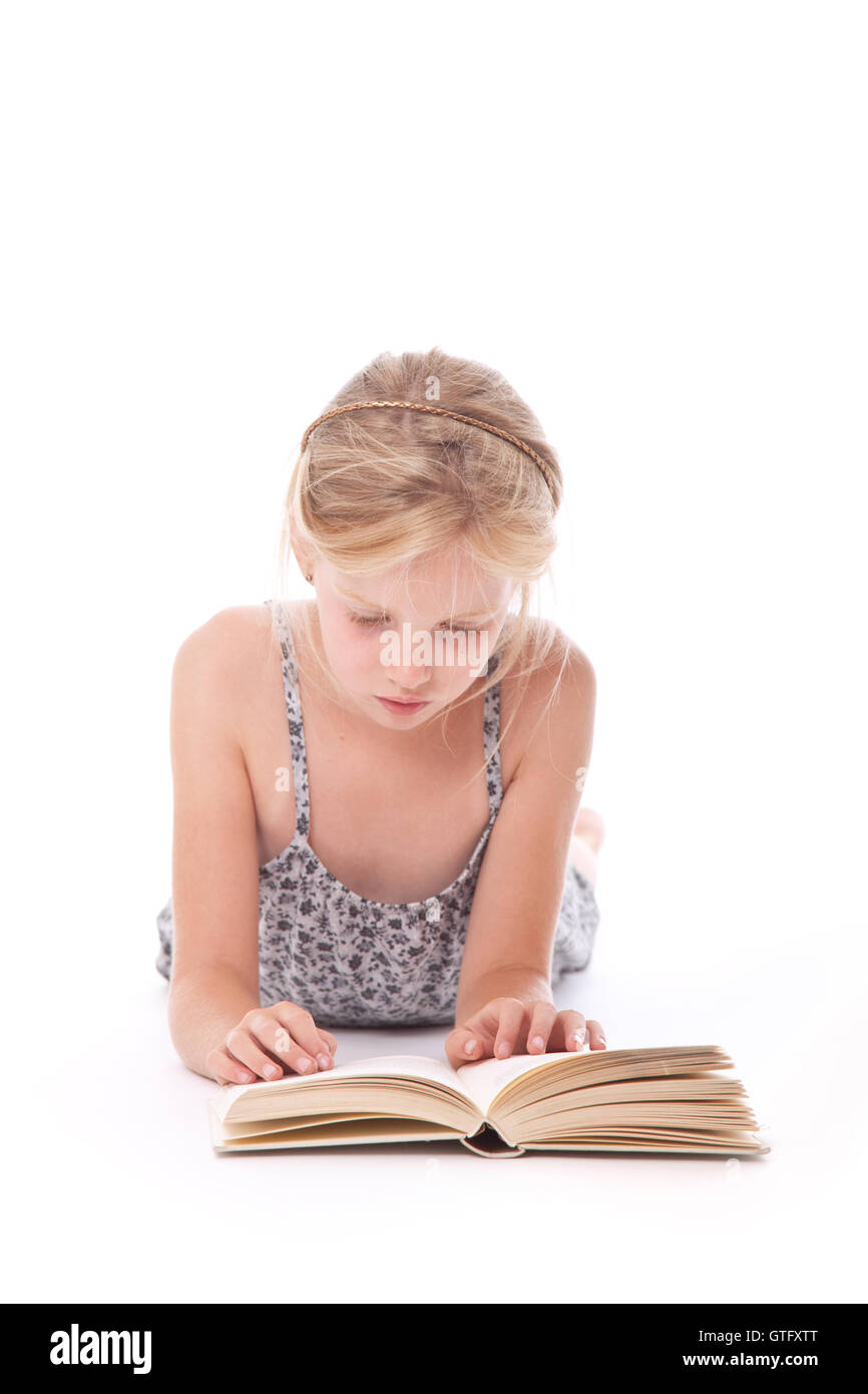 young girl reading a book against white background Stock Photo - Alamy