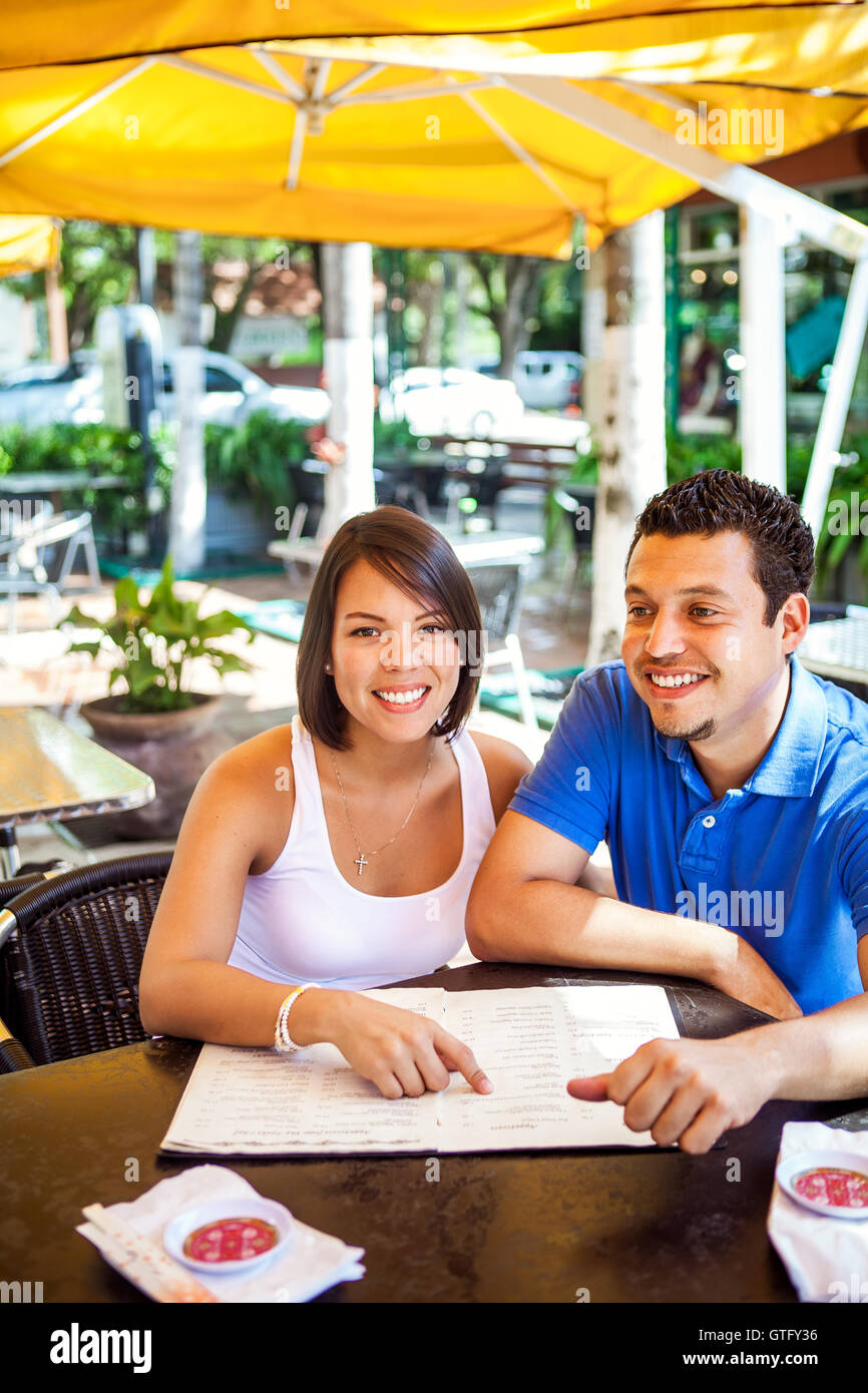 Beautiful latin couple in a restaurant Stock Photo - Alamy
