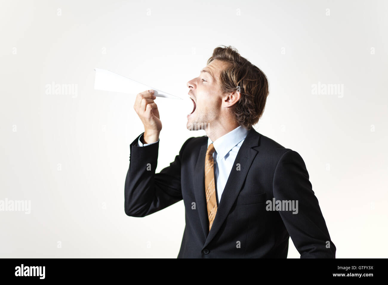 Businessman eating paper airplane hi-res stock photography and images ...