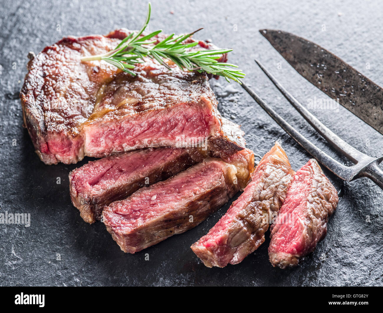 Medium Ribeye steak with spices on the graphite tray Stock Photo - Alamy