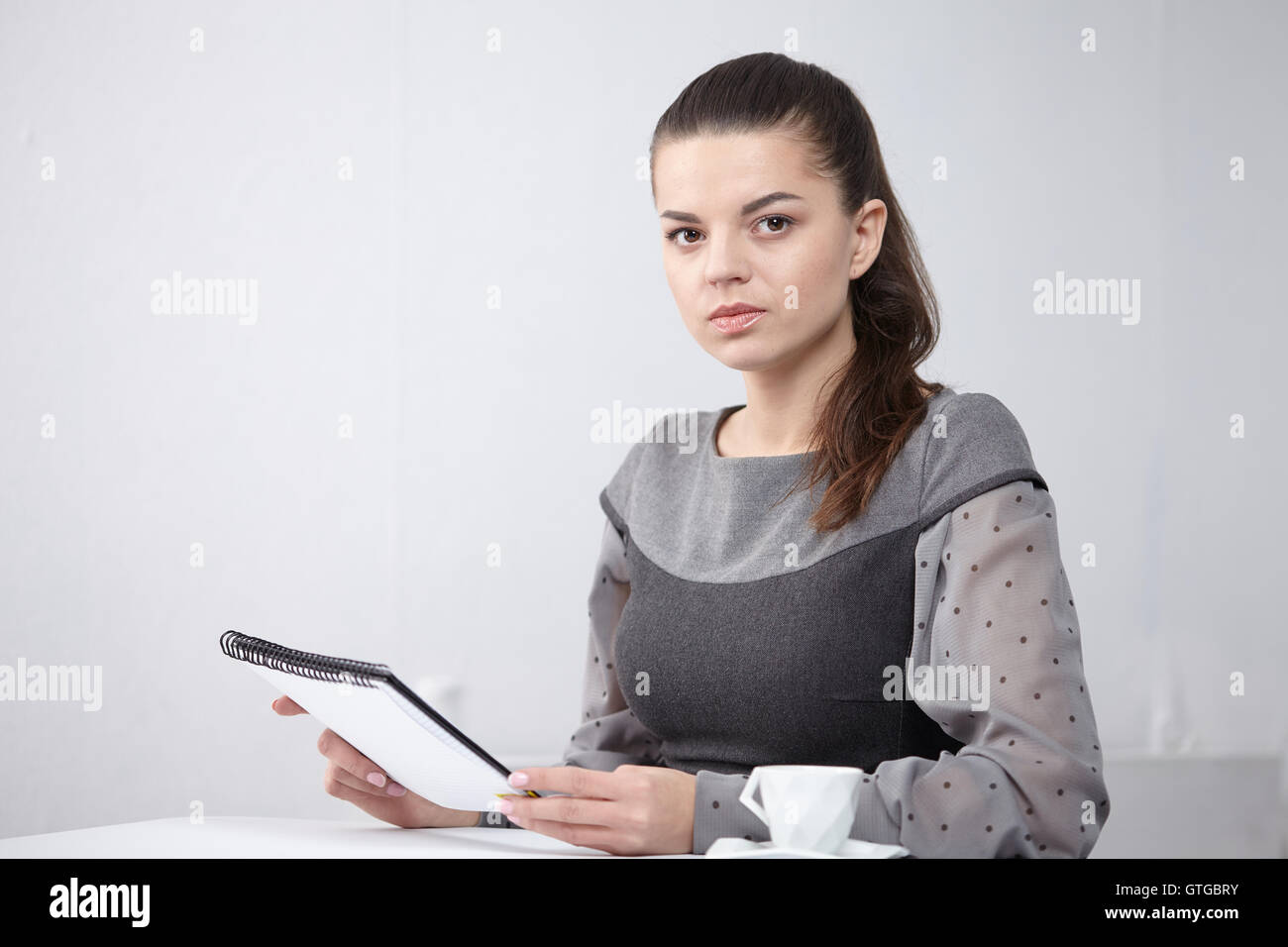 Business lady with a notepad in the office Stock Photo - Alamy