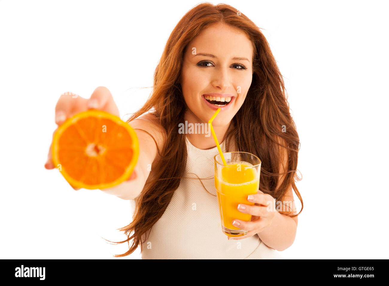 Woman drinking orange juice smiling showing oranges. Young beautiful ...