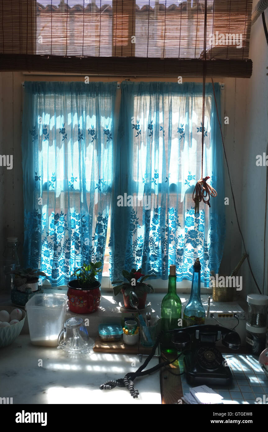 Kitchen window with blue curtain Stock Photo - Alamy