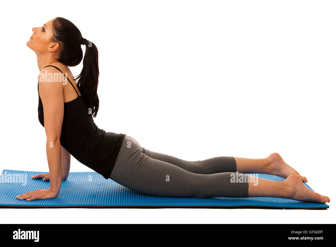 Young pretty woman doing yoga stretching exercises isolated over white ...