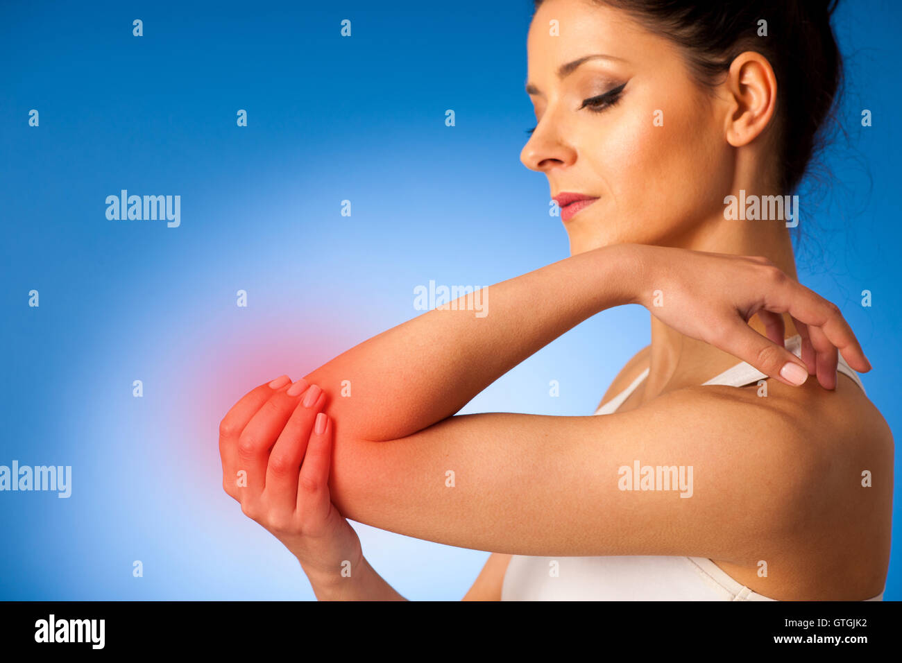 young woman having pain in injured elbow Stock Photo - Alamy