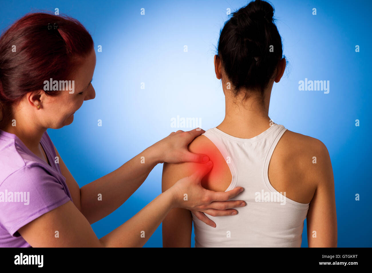 physio therapist helping Woman having pain in her back - back injury ...