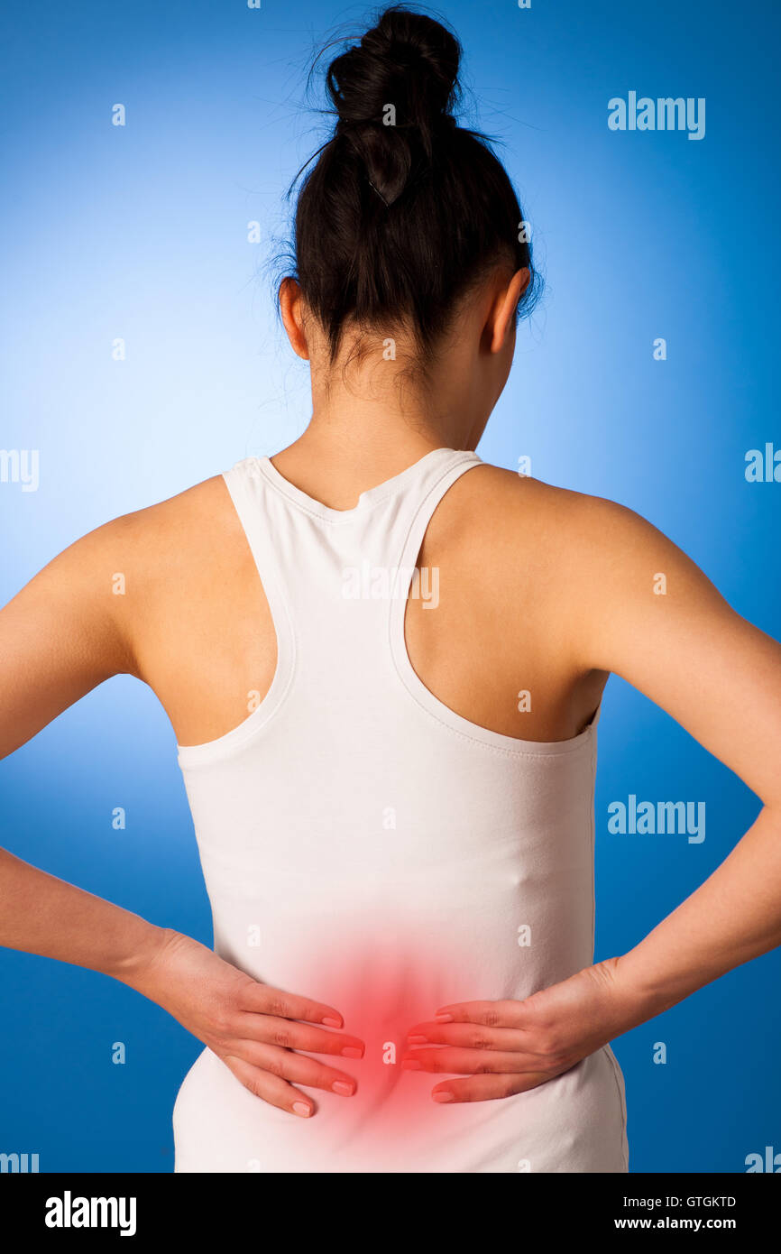 Woman having pain in her back - back injury Stock Photo - Alamy
