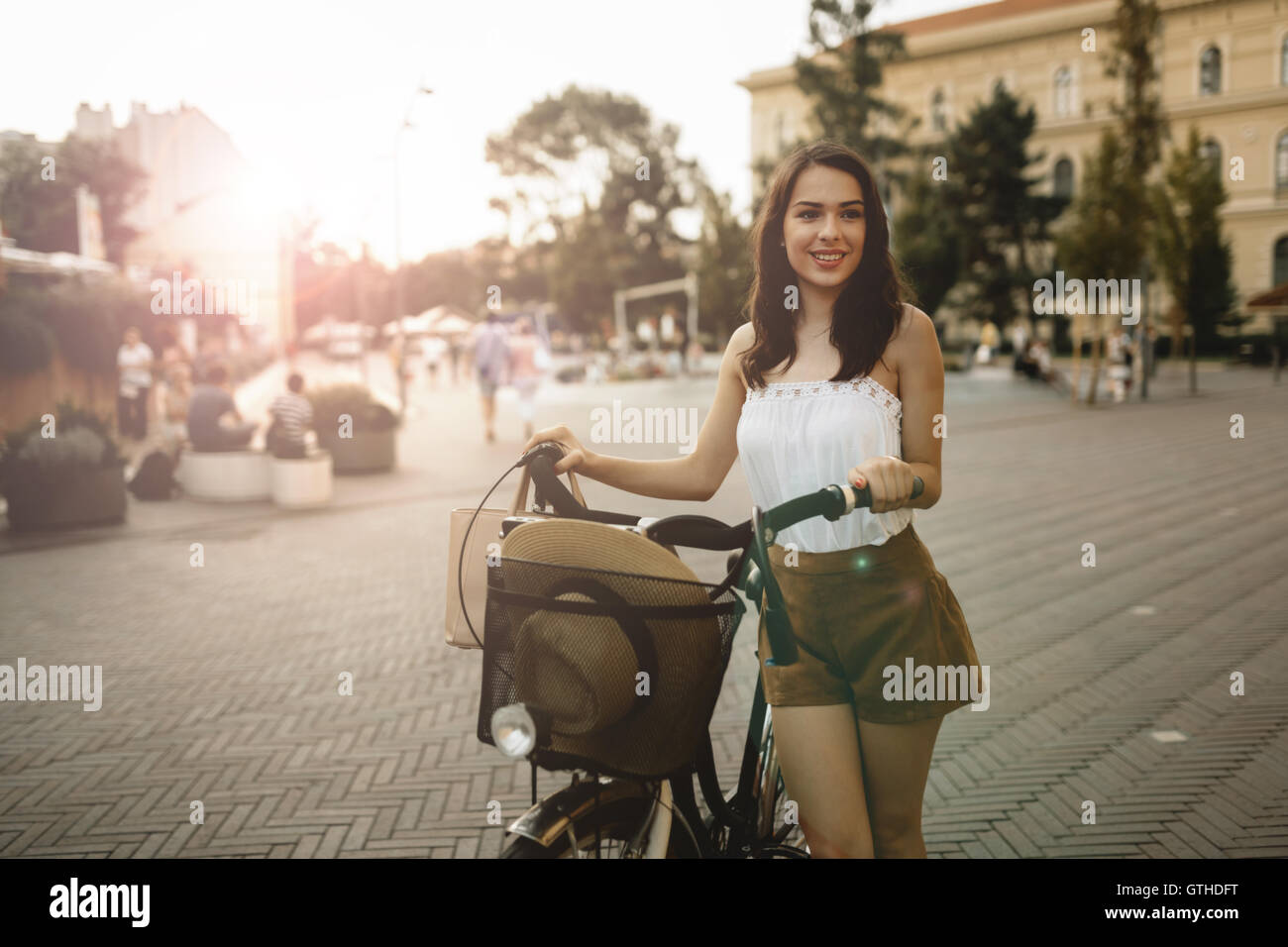Beautiful woman using bike instead of car Stock Photo - Alamy
