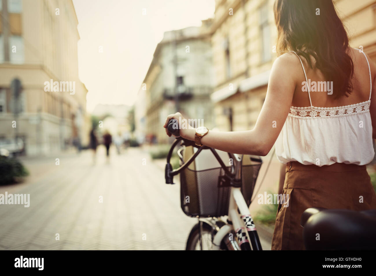 Beautiful woman using bike instead of car Stock Photo - Alamy