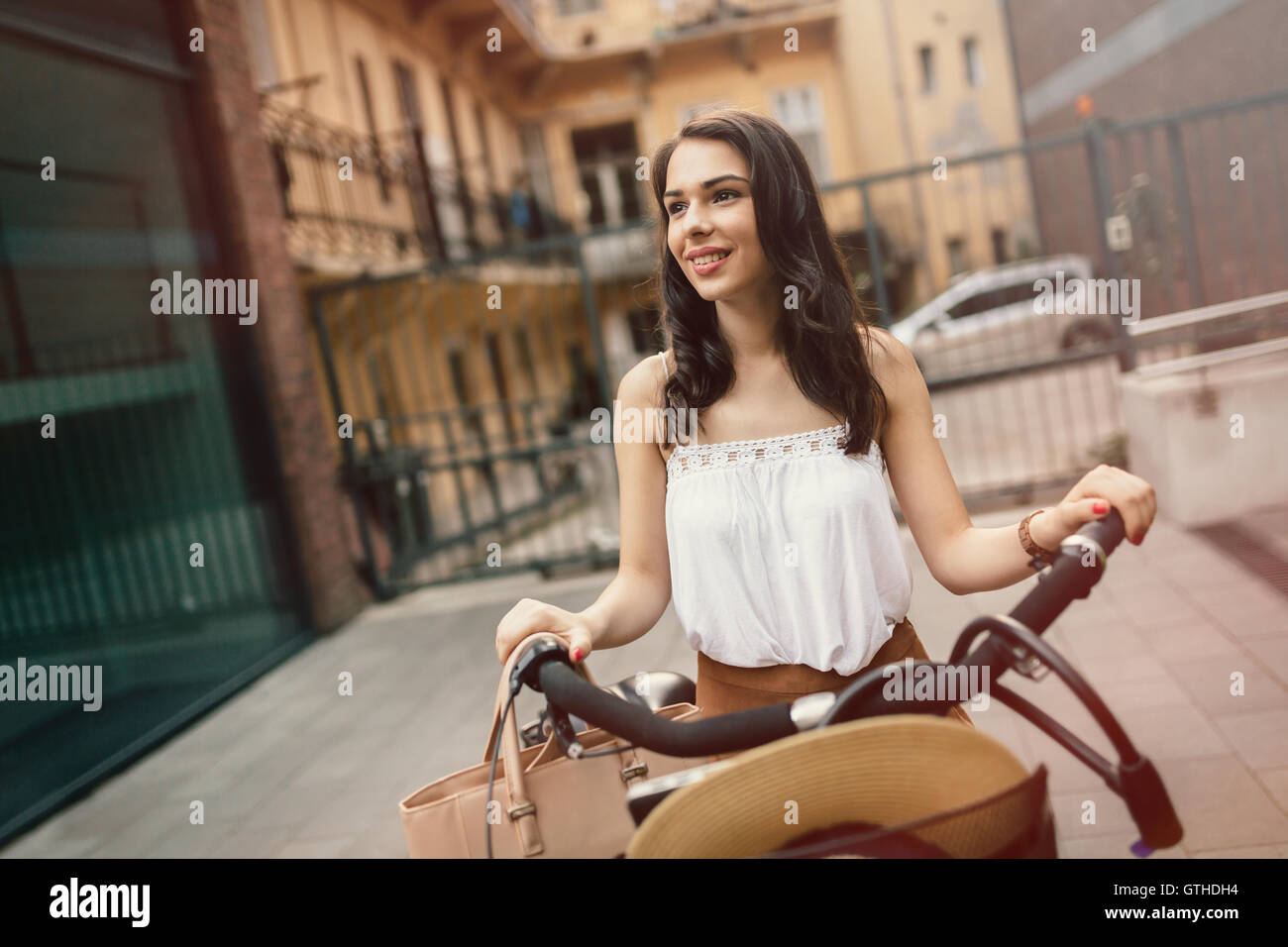 Beautiful woman using bike instead of car Stock Photo - Alamy
