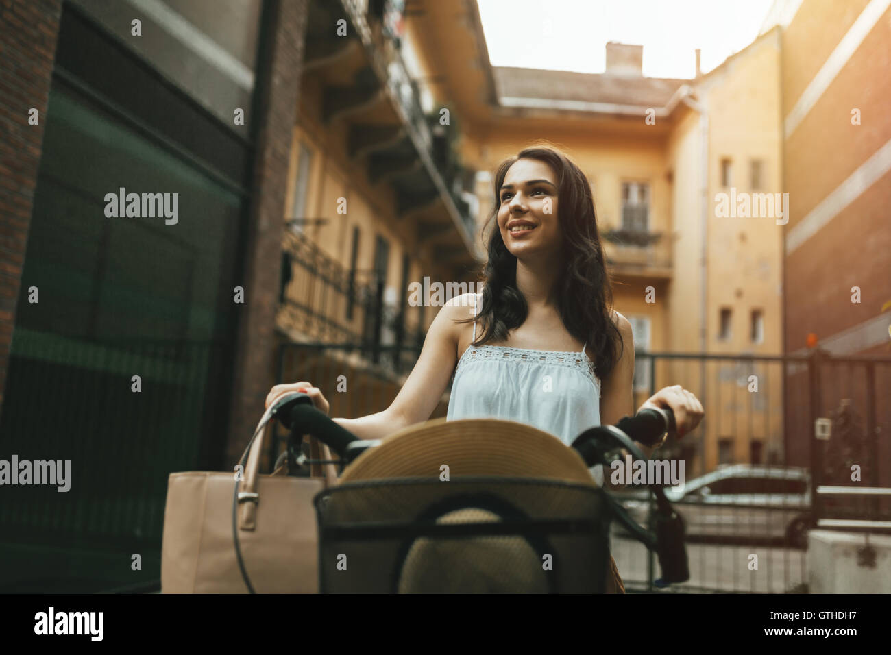 Beautiful woman using bike instead of car Stock Photo - Alamy