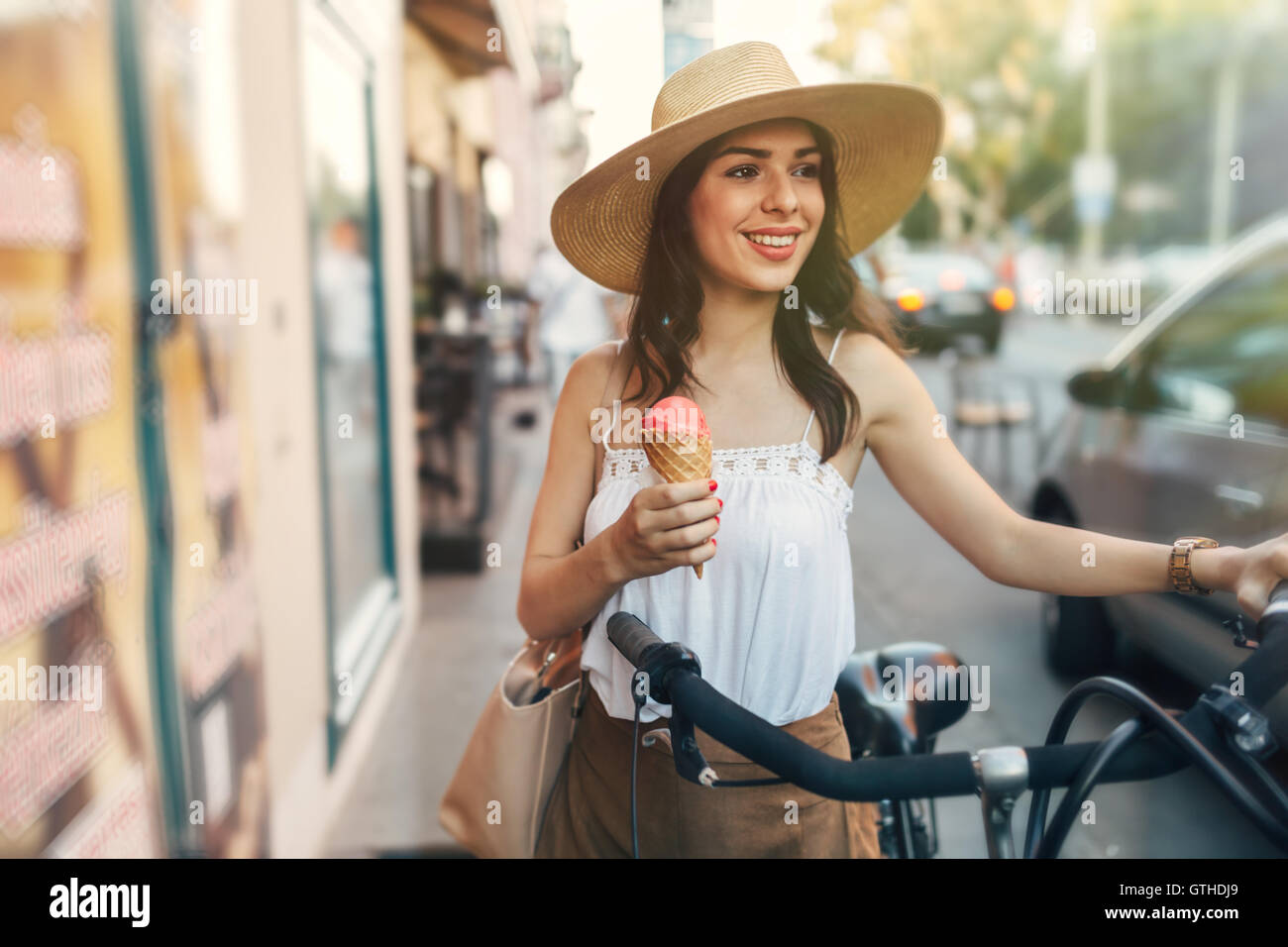 Beautiful woman eating ice cream outdoors Stock Photo - Alamy