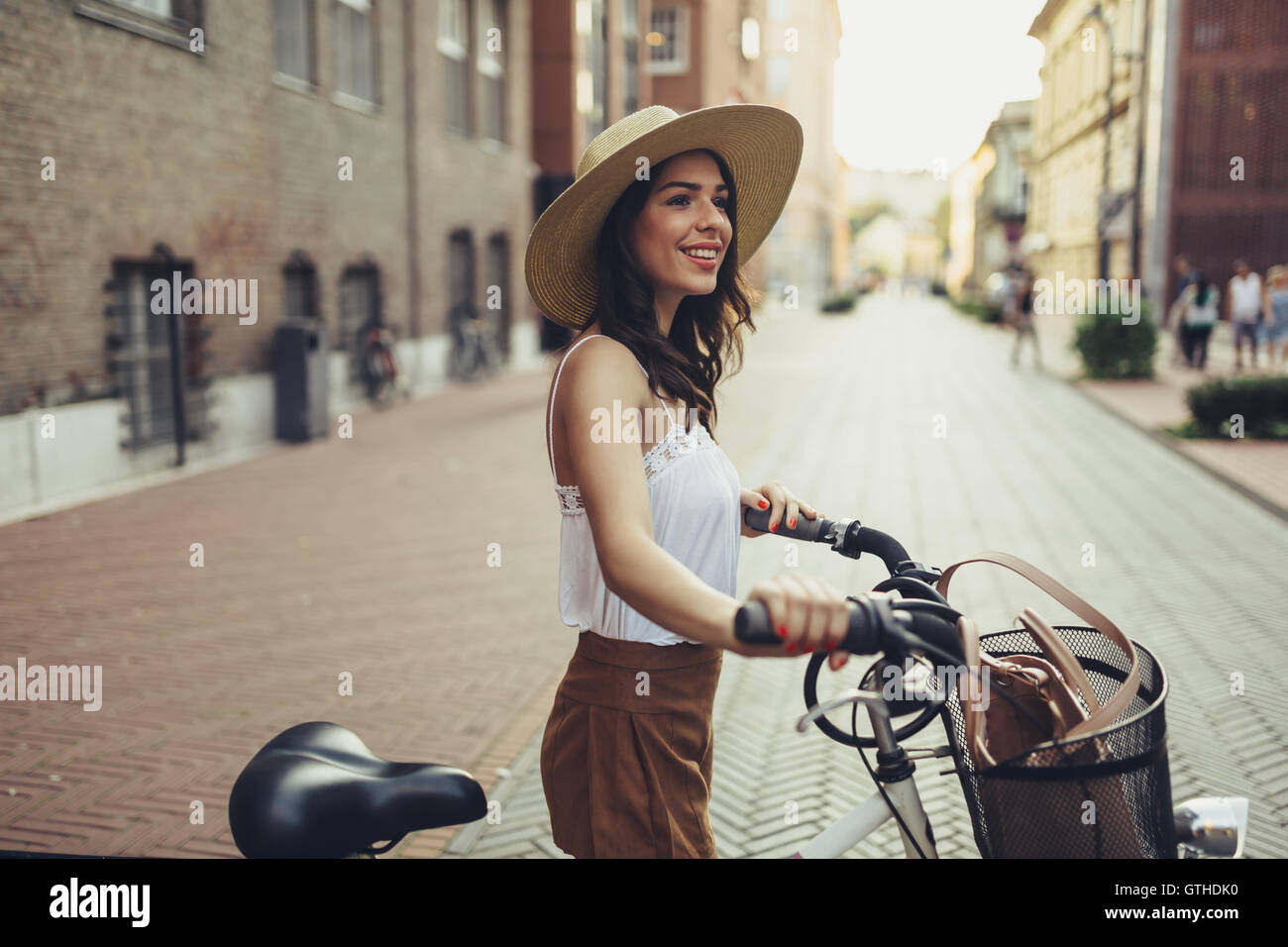 Beautiful woman using bike instead of car Stock Photo - Alamy