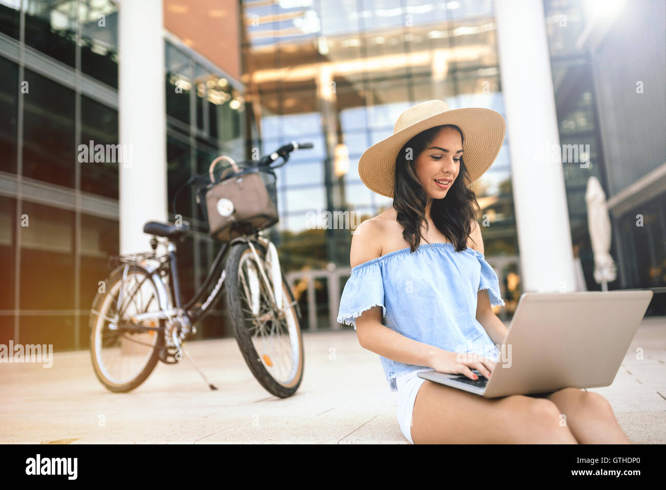 Female student using laptop outdoors and studying Stock Photo - Alamy