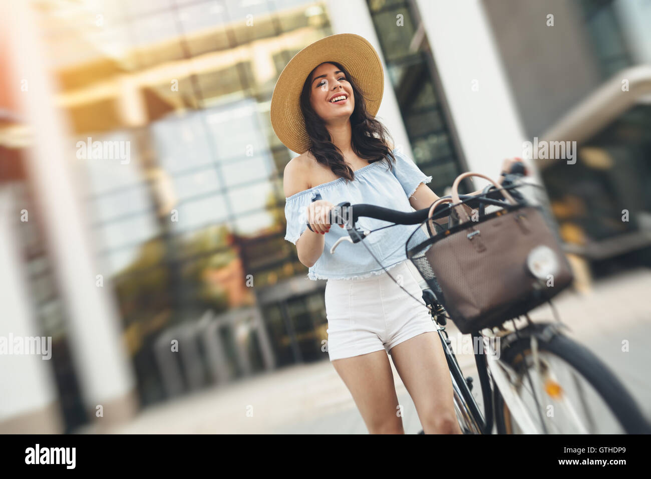 Beautiful woman using bike instead of car Stock Photo - Alamy