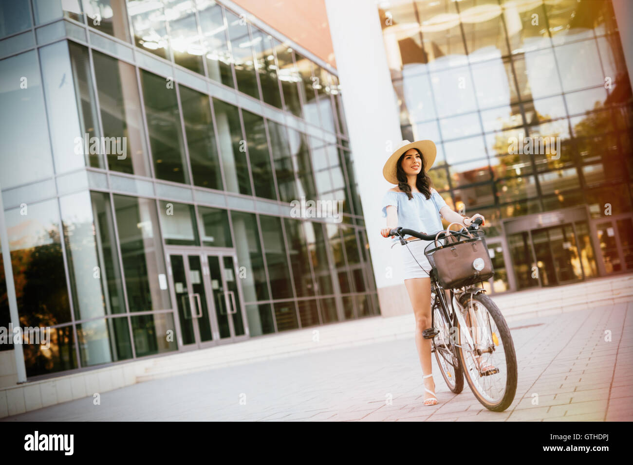 Beautiful woman using bike instead of car Stock Photo - Alamy