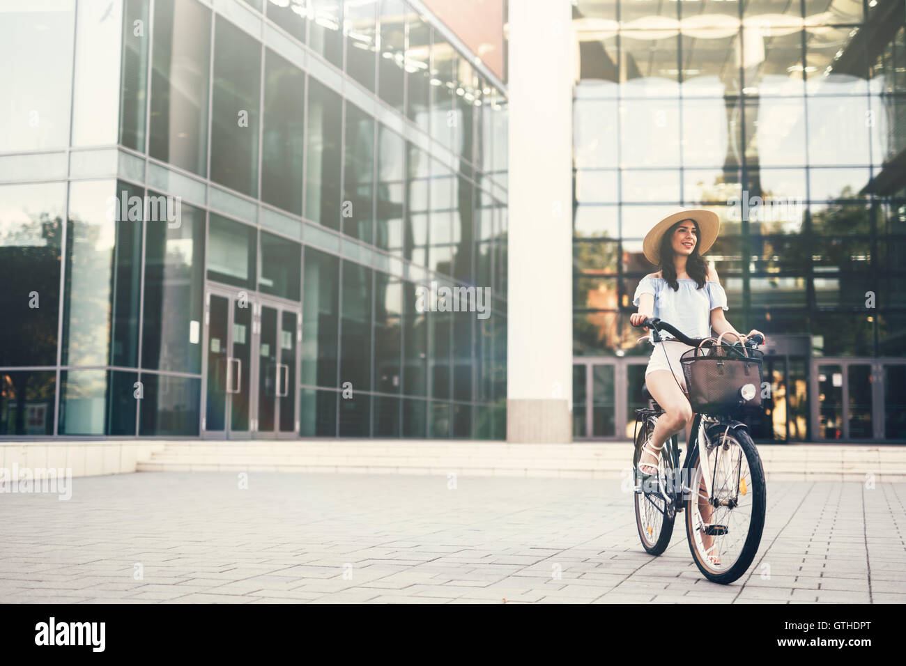 Beautiful woman using bike instead of car Stock Photo - Alamy