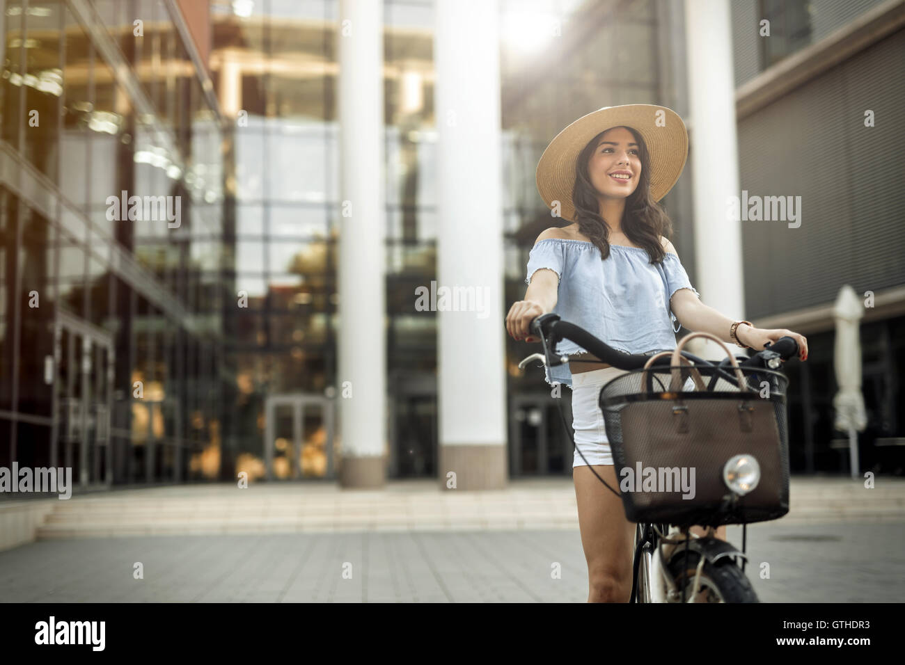 Beautiful woman using bike instead of car Stock Photo - Alamy