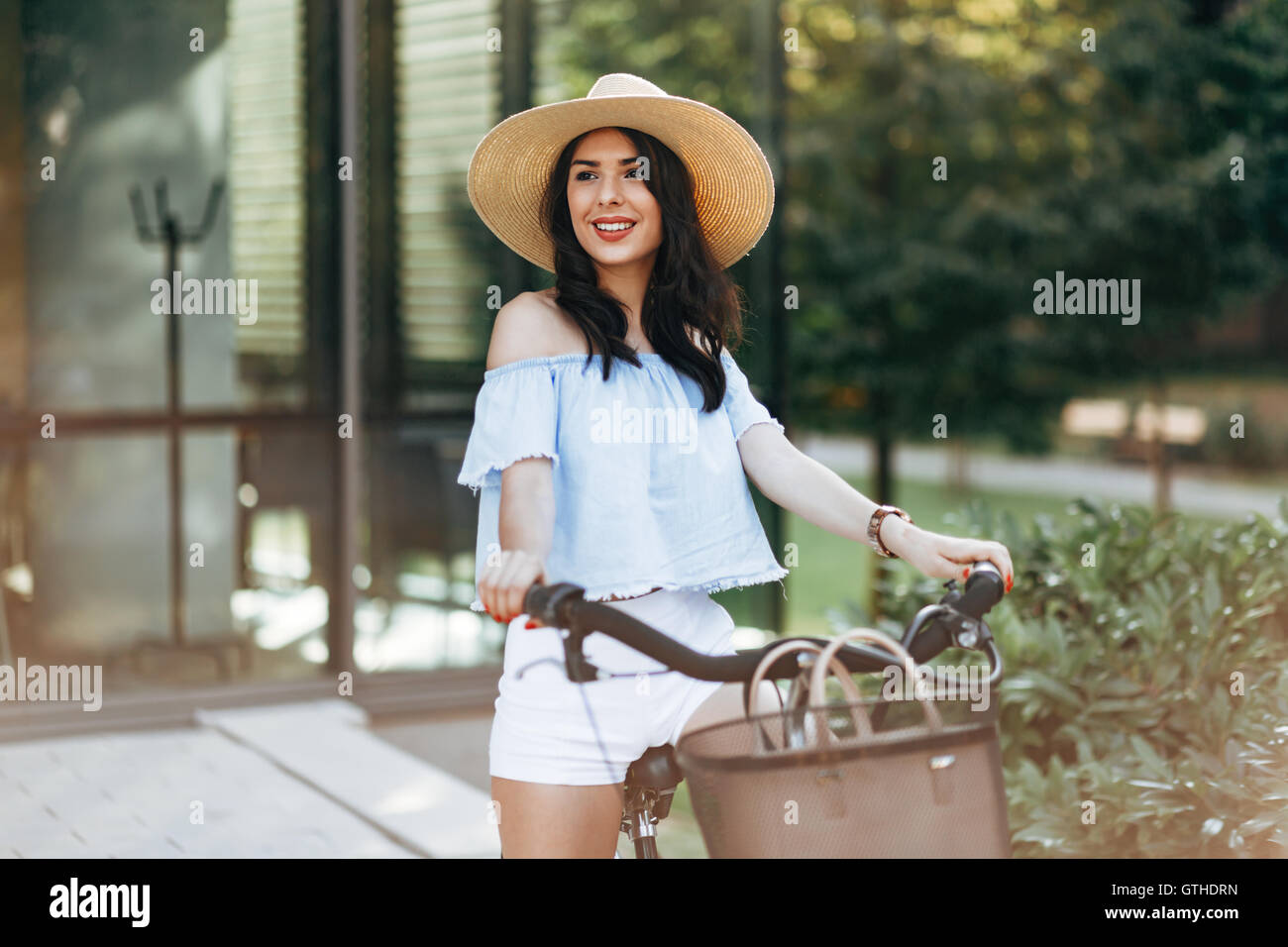 Beautiful woman using bike instead of car Stock Photo - Alamy