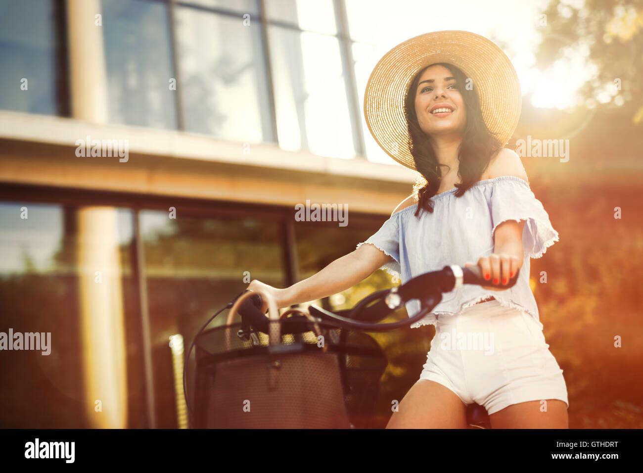 Beautiful woman using bike instead of car Stock Photo - Alamy