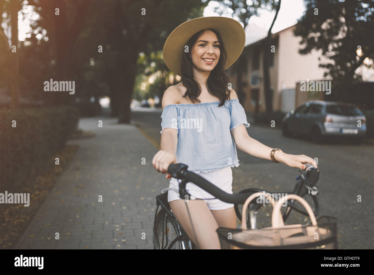 Beautiful woman using bike instead of car Stock Photo - Alamy