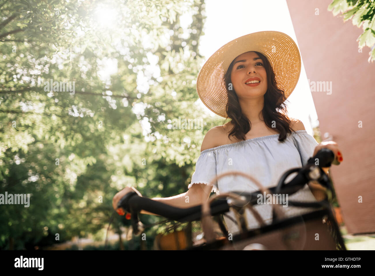 Beautiful woman using bike instead of car Stock Photo - Alamy