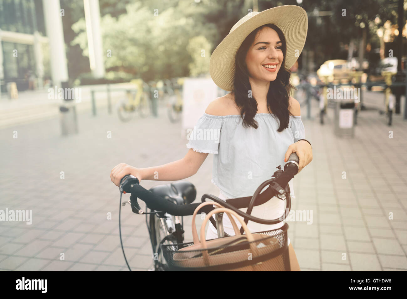 Beautiful woman using bike instead of car Stock Photo - Alamy