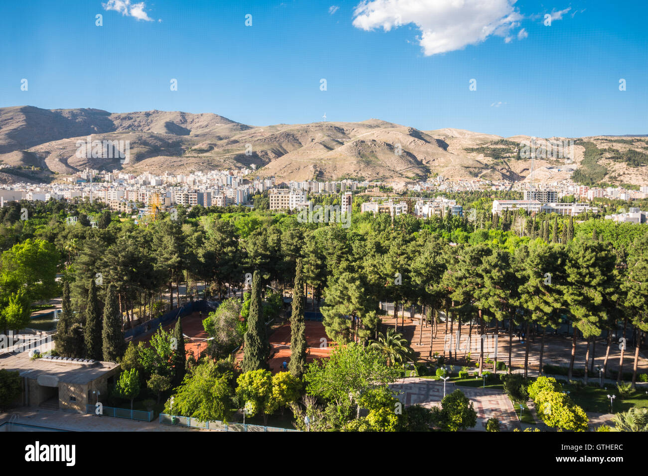 The skyline of Shiraz, Iran, with mountains and apartment buildings and ...