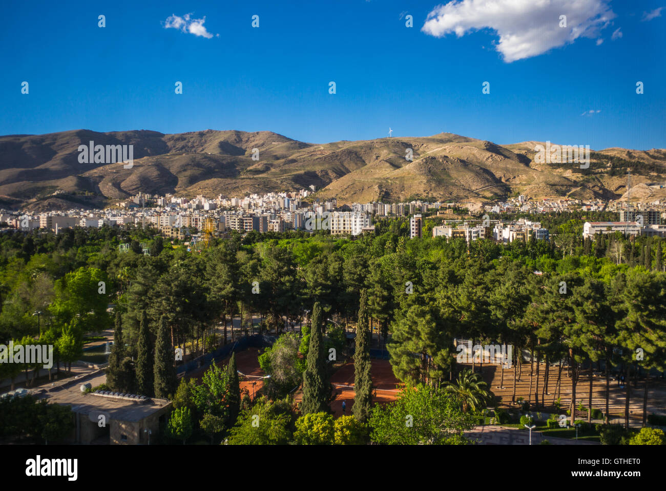 The skyline of Shiraz, Iran, with mountains and apartment buildings and ...