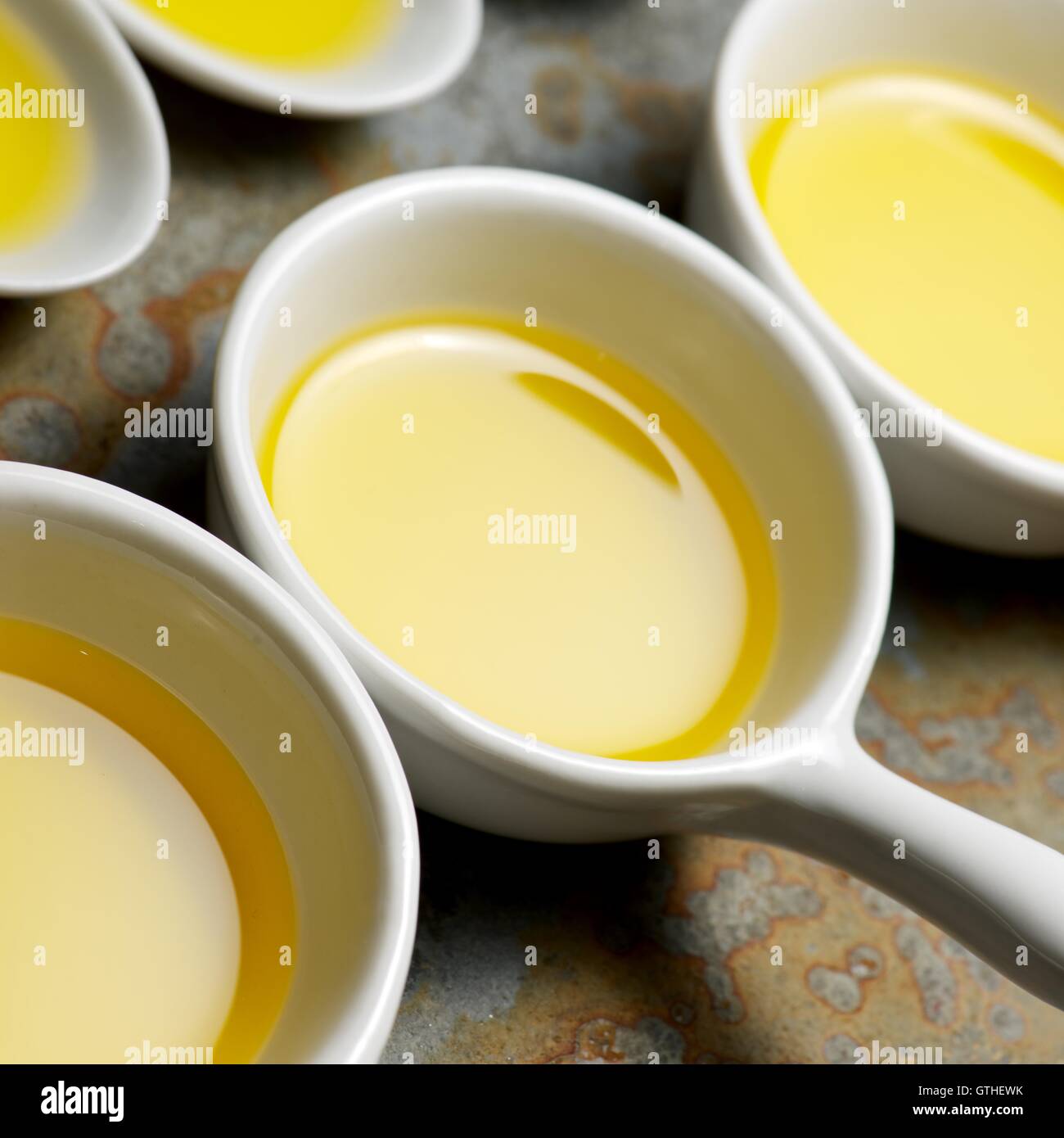 Olive oil in a small china spoons Stock Photo - Alamy