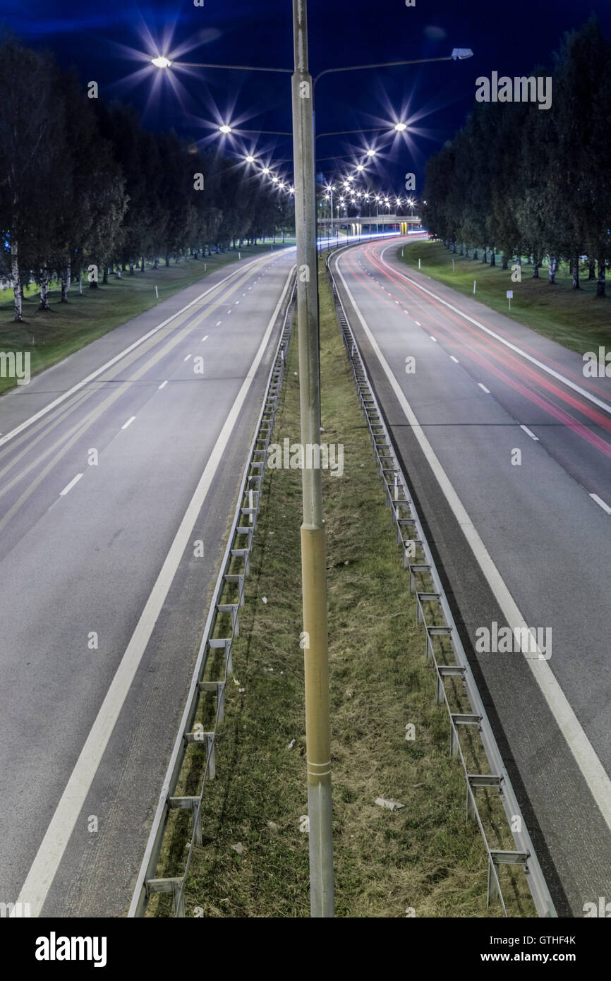 Highway Road with Trees and light trails Stock Photo - Alamy
