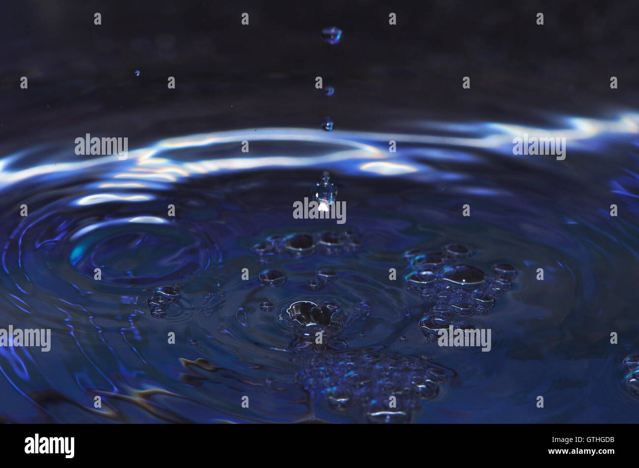 Blue water drops falling Stock Photo - Alamy