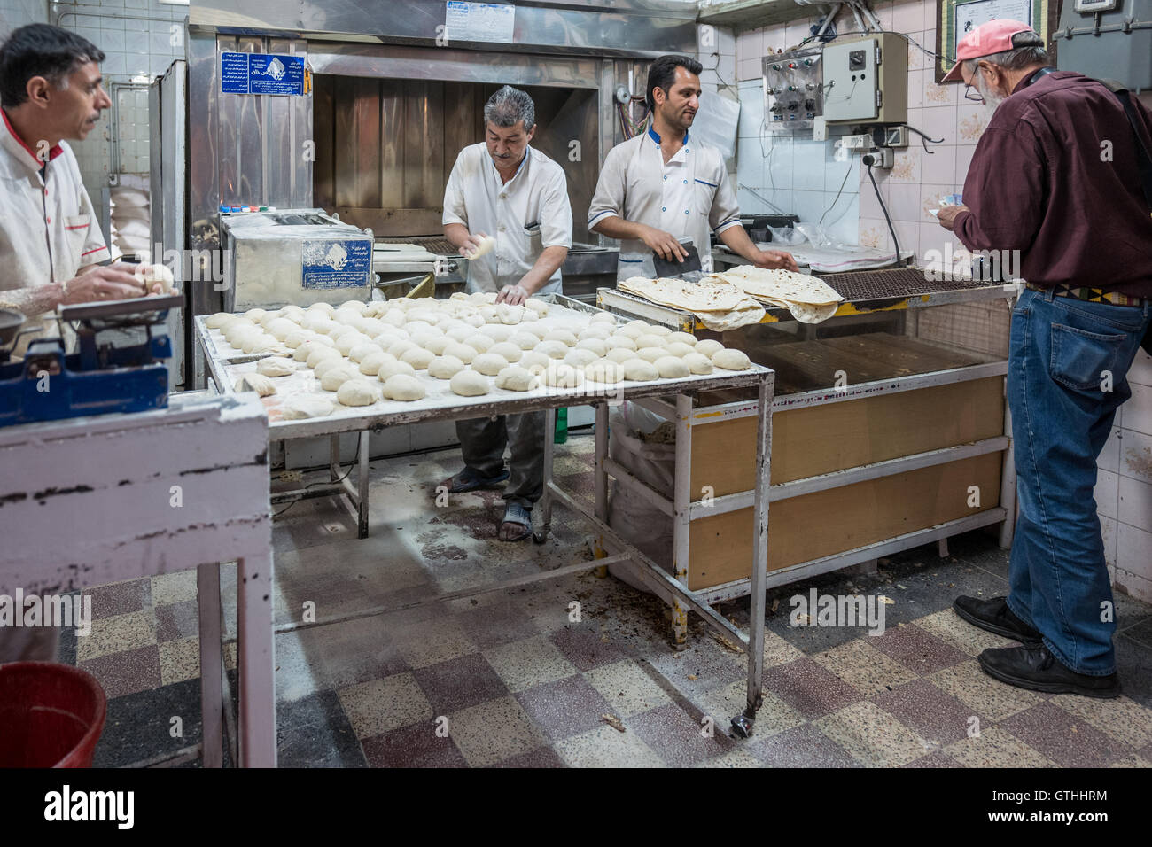 Bakers working in an automated bakery making Iranian flat bread Stock ...