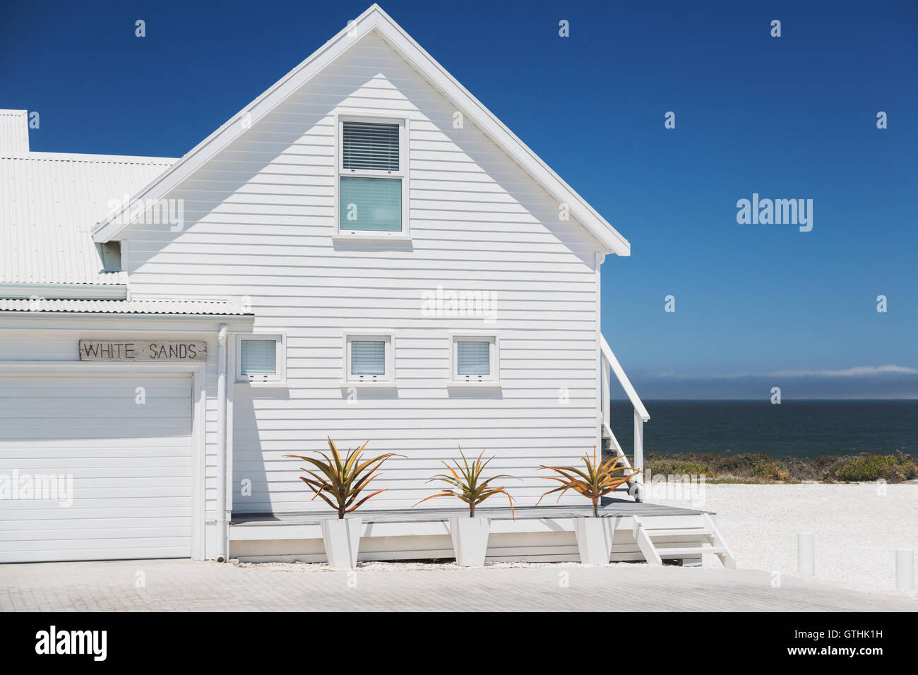 White beach house with sunny ocean view Stock Photo - Alamy