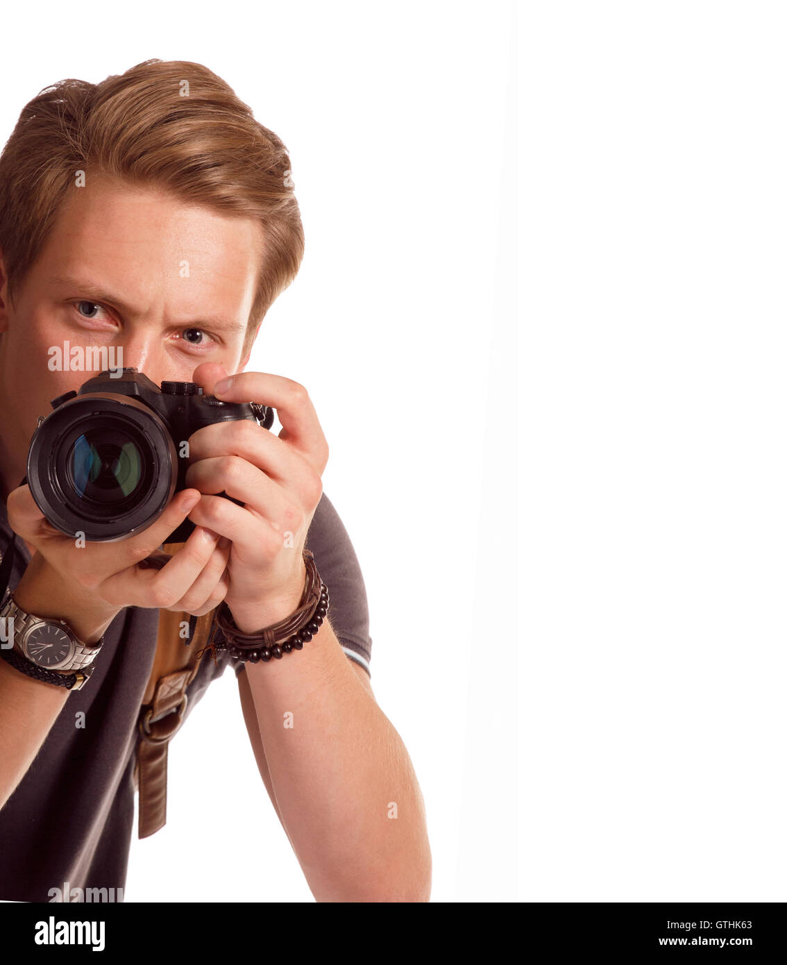 Closeup portrait of a young man taking a picture from corner over white ...