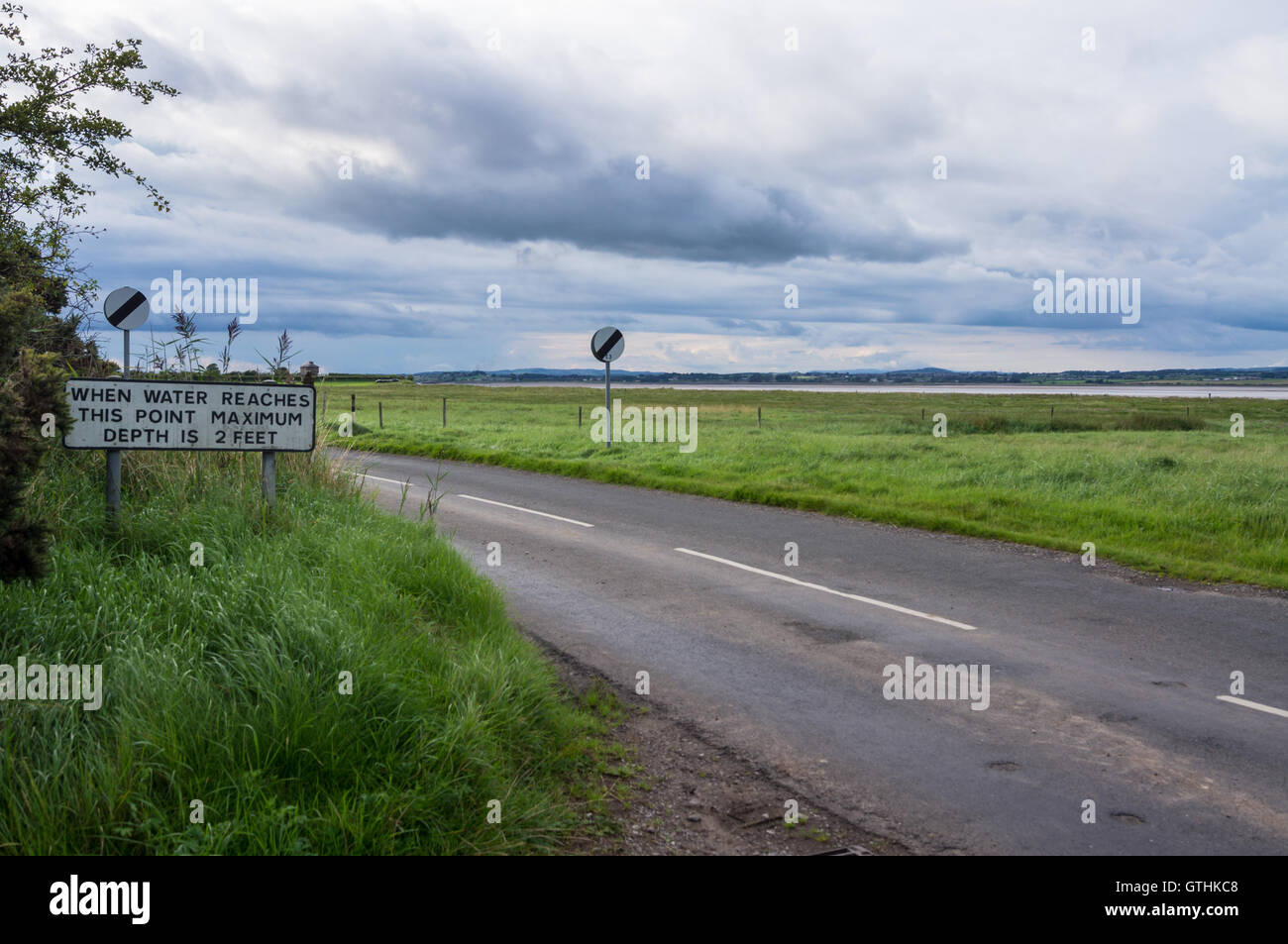 Tidal flood warning sign on the road into Bowness-on Solway, Cumbria ...