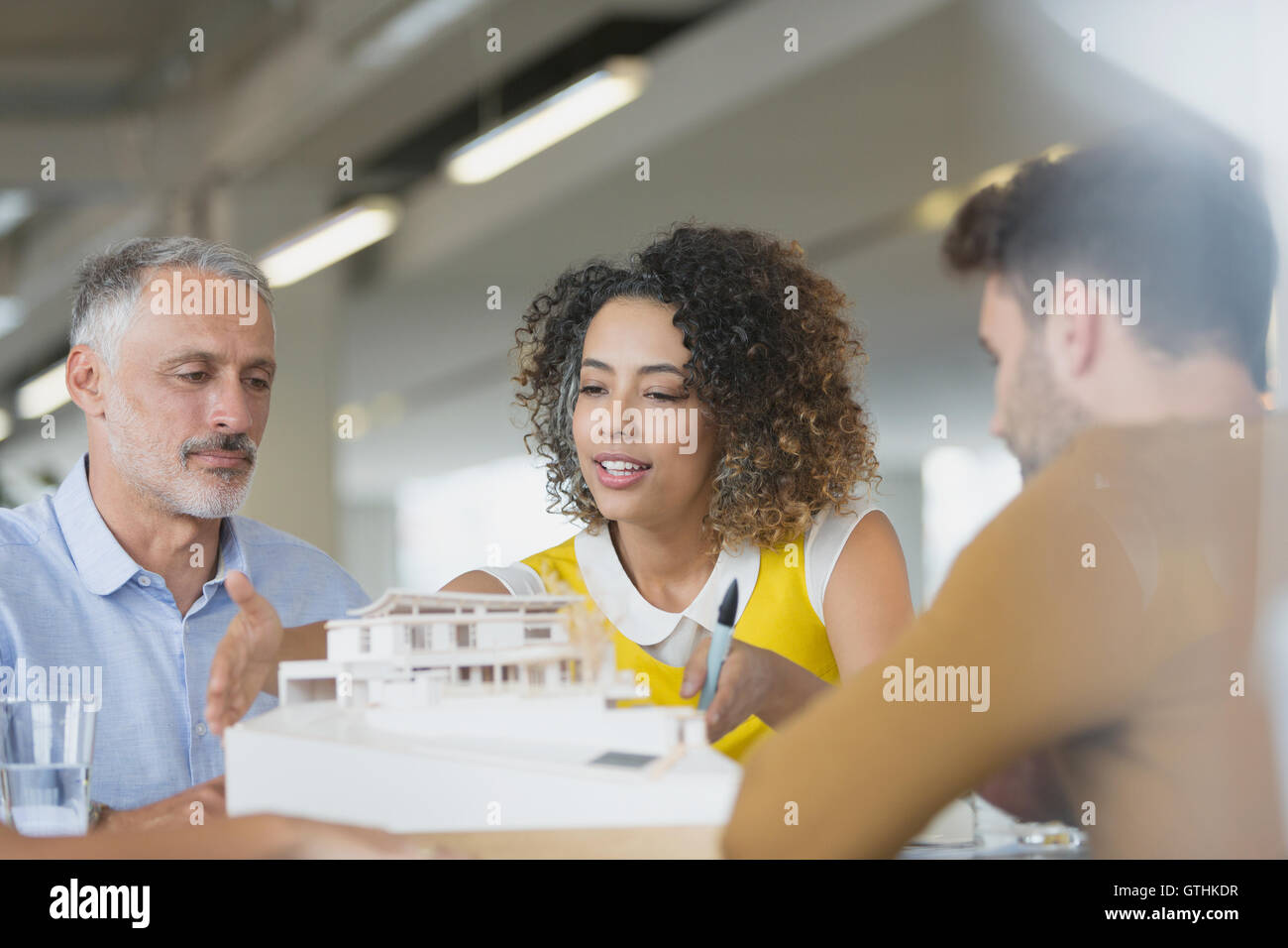Architects discussing model in meeting Stock Photo - Alamy