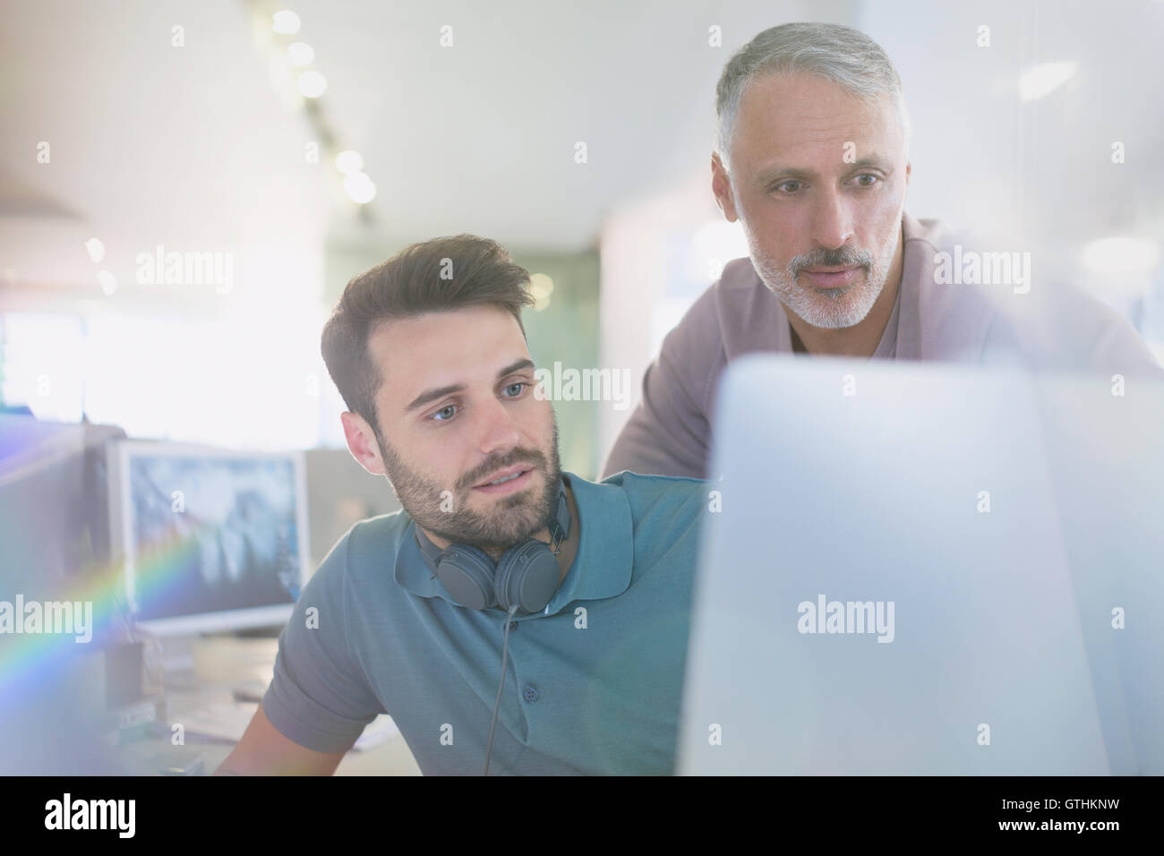 Creative businessmen working at computer in office Stock Photo - Alamy